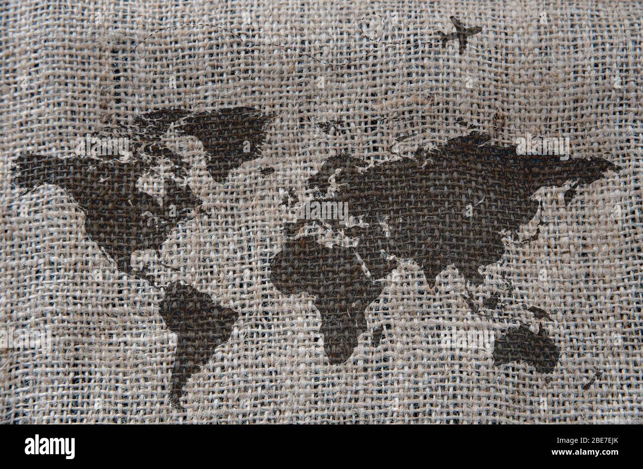 A map of the world drawn on a rough gray cloth, the plane flies over ...