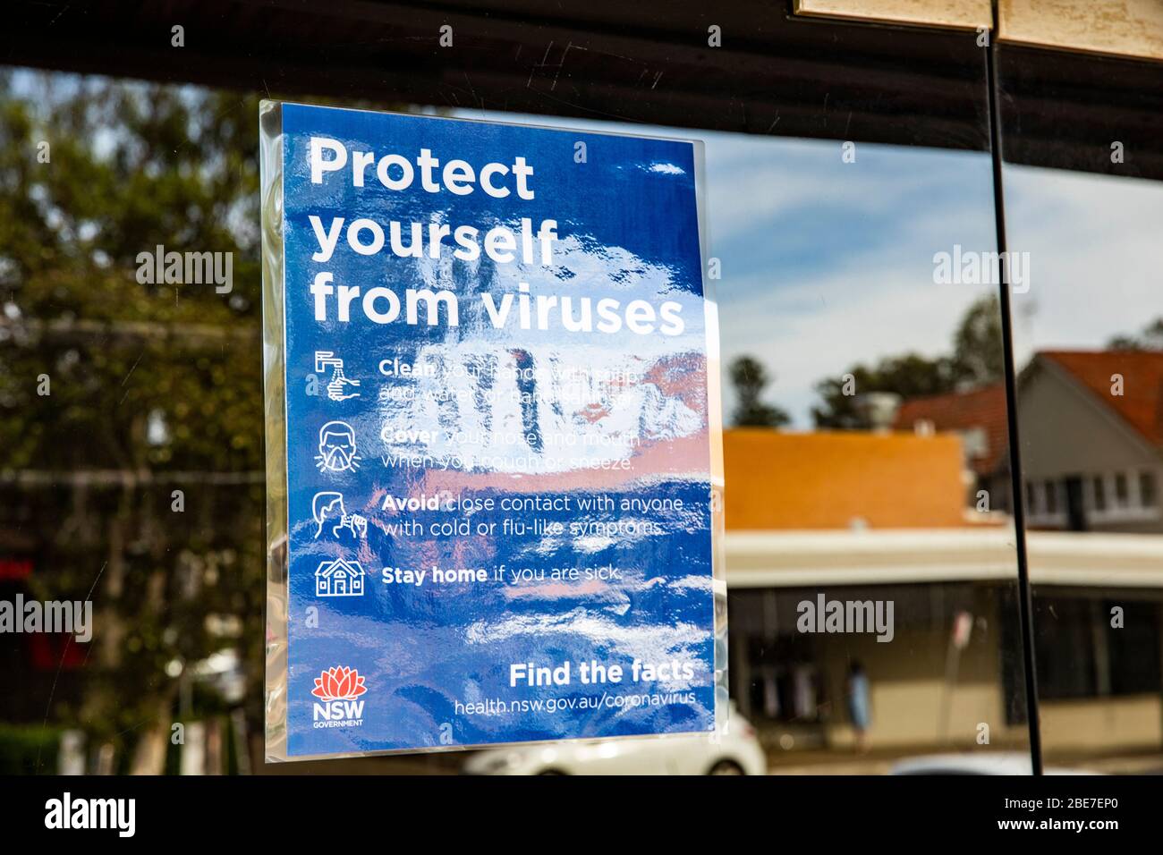 NSW health sign in a Sydney shop window giving advice on protect ...