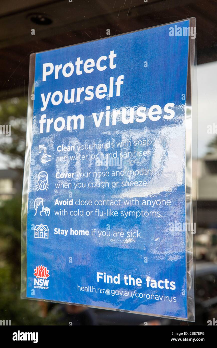 NSW health sign in a Sydney shop window giving advice on protect ...