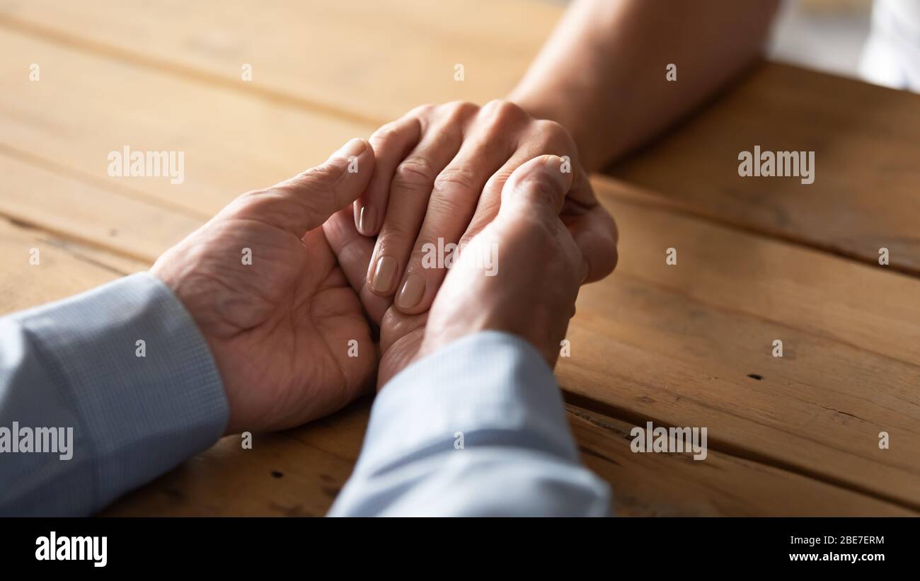 Loving caring older husband holding wife hand, support and empathy ...