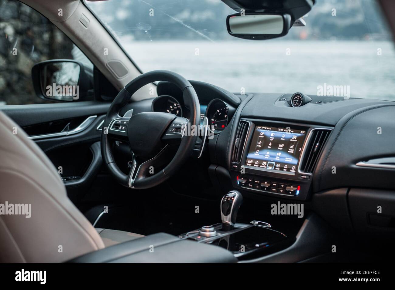 Navigation monitor, control wheel and front seat of a black car Stock ...