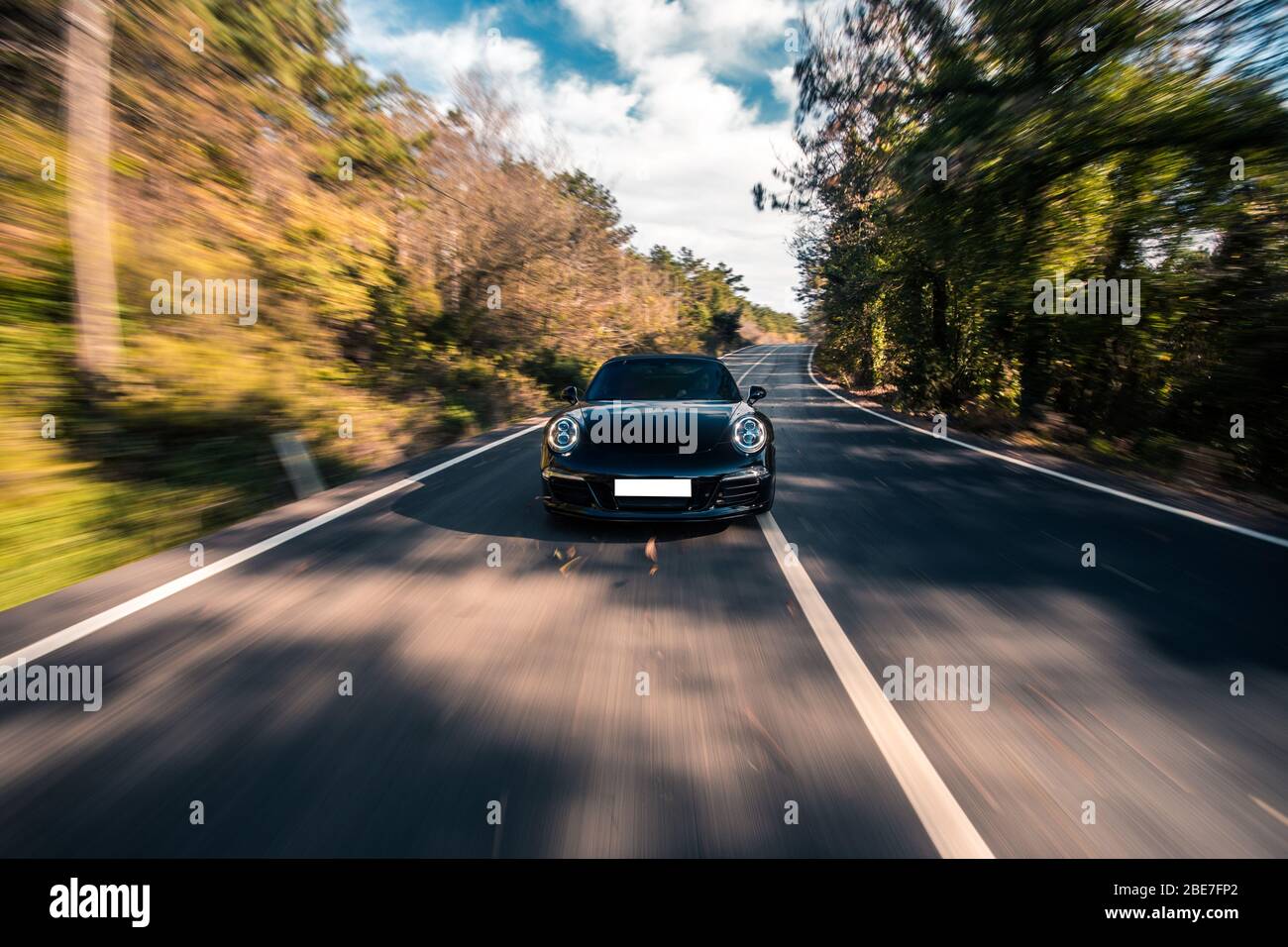 Black super model sedan car on the forest road with high speed Stock ...