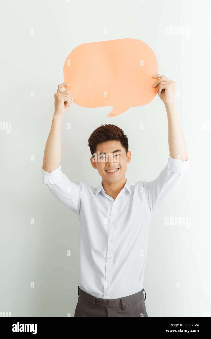 Handsome asian man holding a cardboard speech bubble paper Stock Photo ...