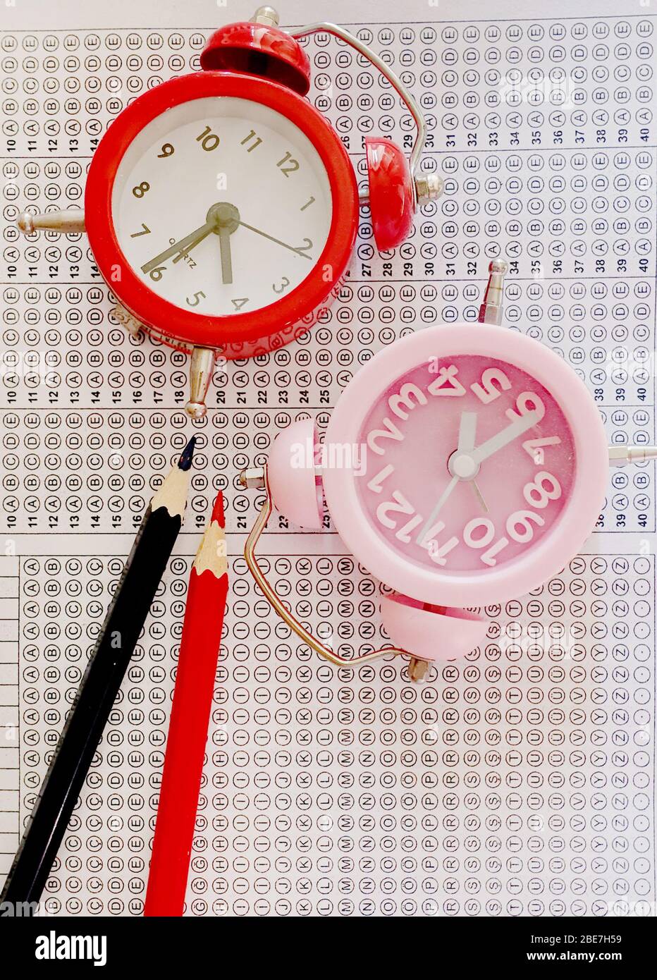 Pencil and clock on answer sheet- test exam Stock Photo - Alamy