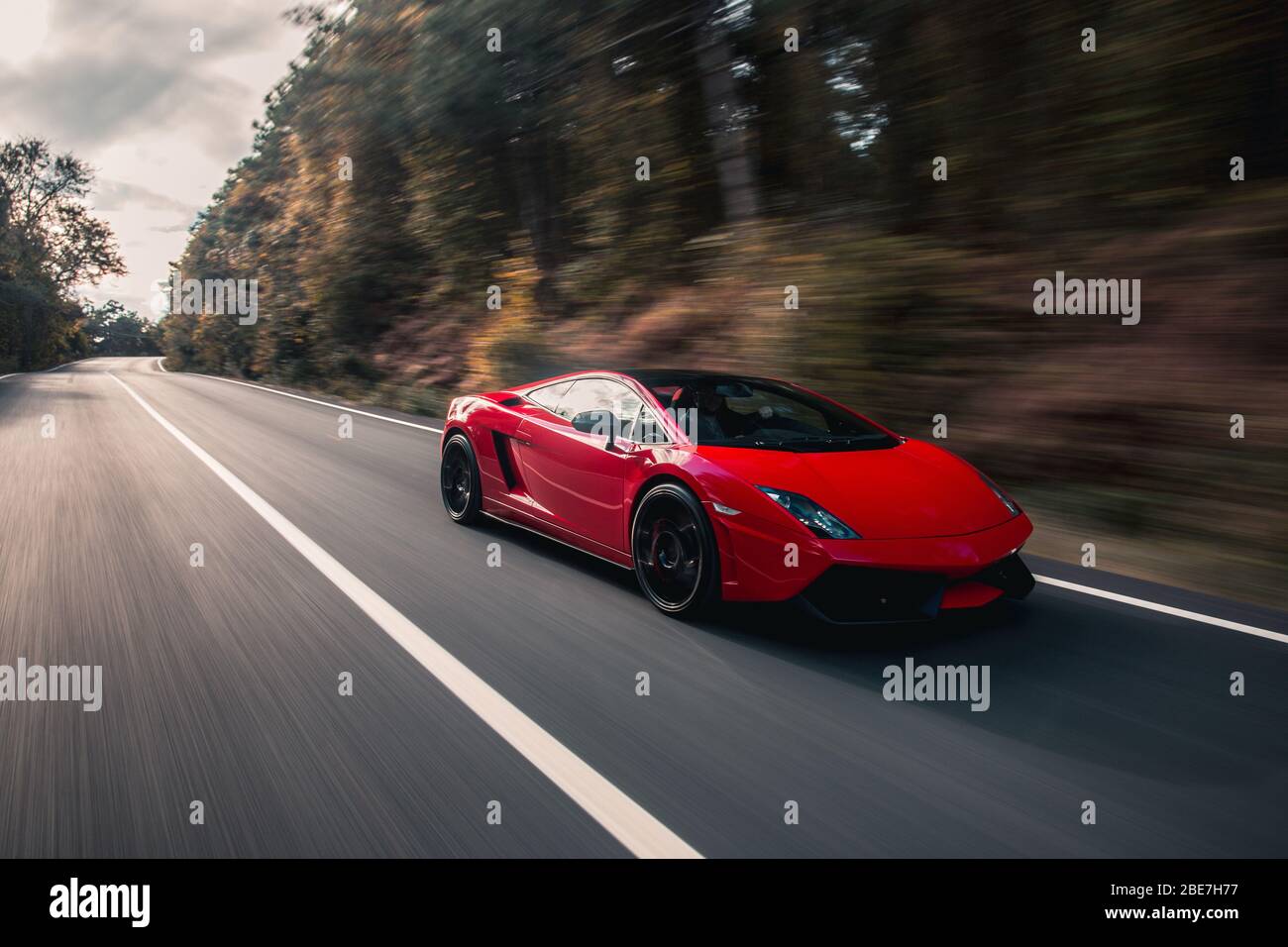 Red super model car in the darkness on the forest,speed drive Stock ...