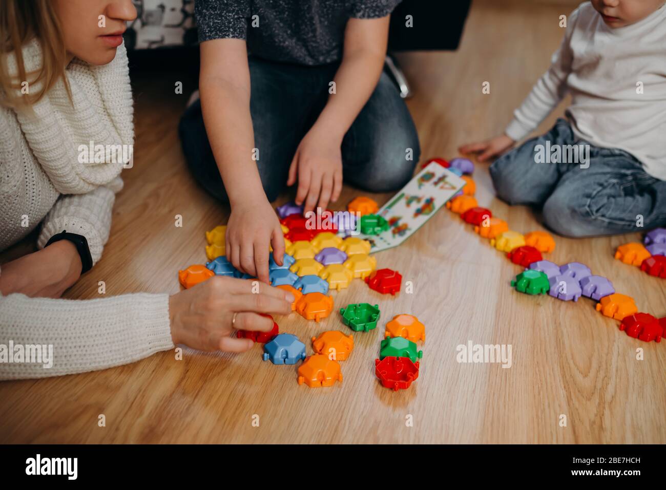 The mother of two boys is engaged in raising children Stock Photo - Alamy