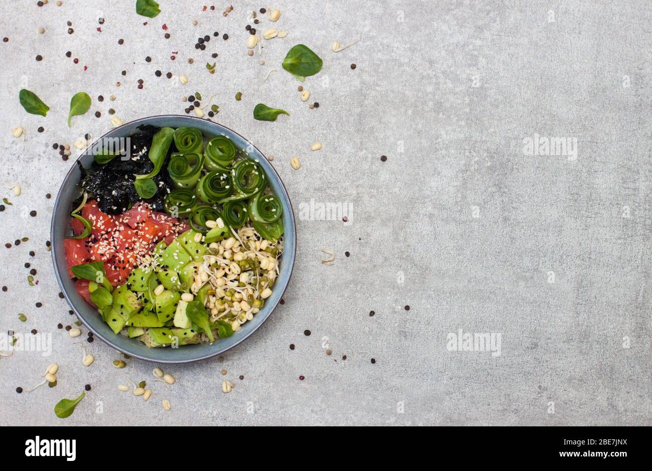 Poke bowl with smoked salmon, cucumber, avocado, sea kale, bean sprouts ...