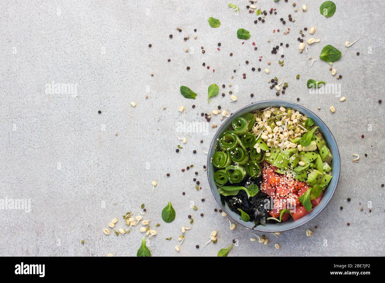 Poke bowl with smoked salmon, cucumber, avocado, sea kale, bean sprouts ...
