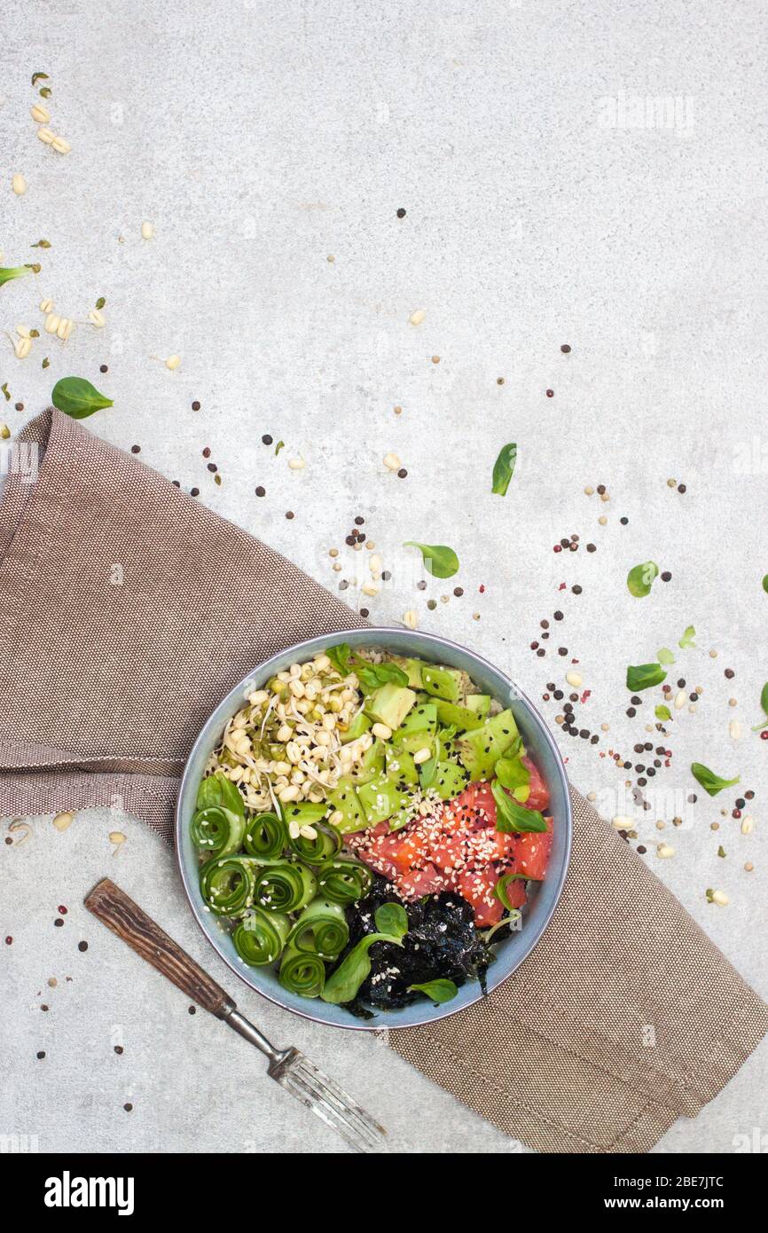 Poke bowl with smoked salmon, cucumber, avocado, sea kale, bean sprouts ...