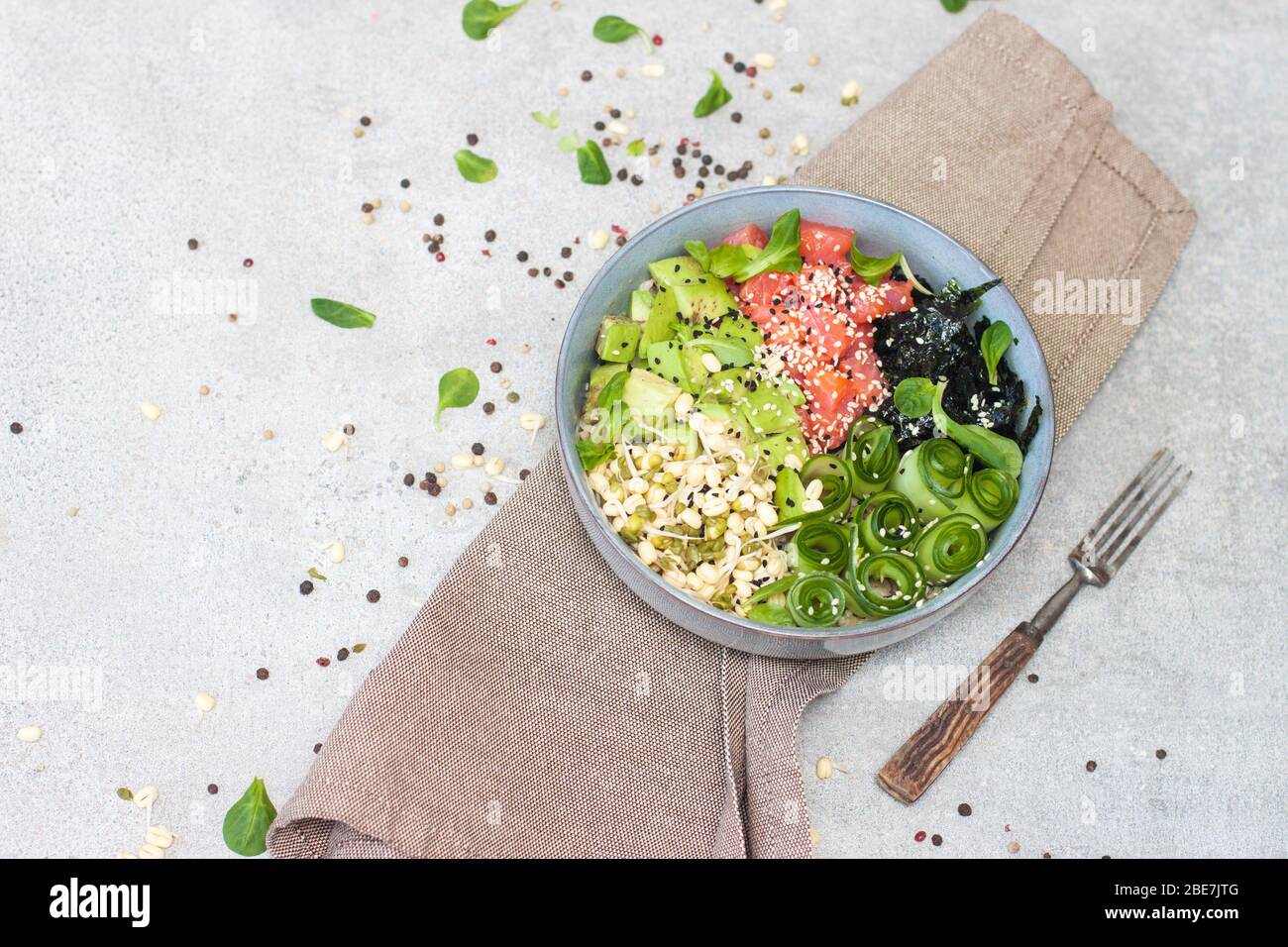 Poke bowl with smoked salmon, cucumber, avocado, sea kale, bean sprouts ...