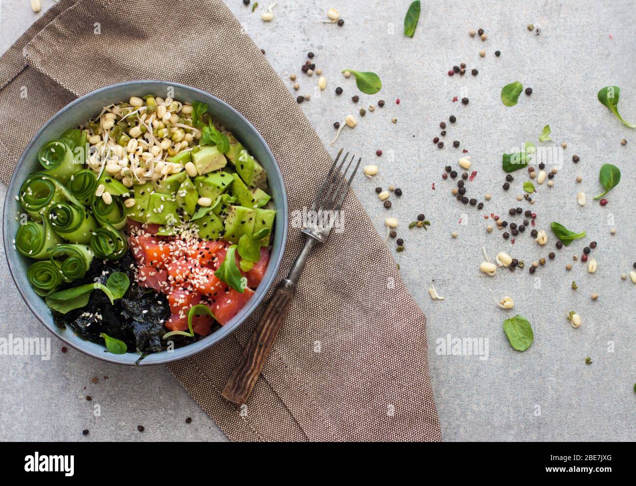 Poke bowl with smoked salmon, cucumber, avocado, sea kale, bean sprouts ...