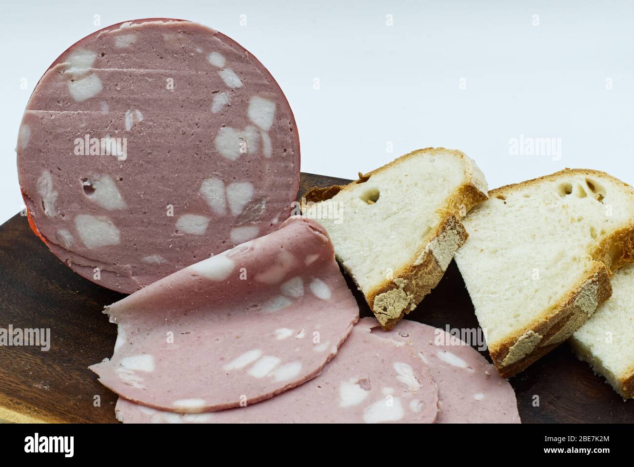 Italian Mortadella bolognese with slices of bread. Pork salami ...