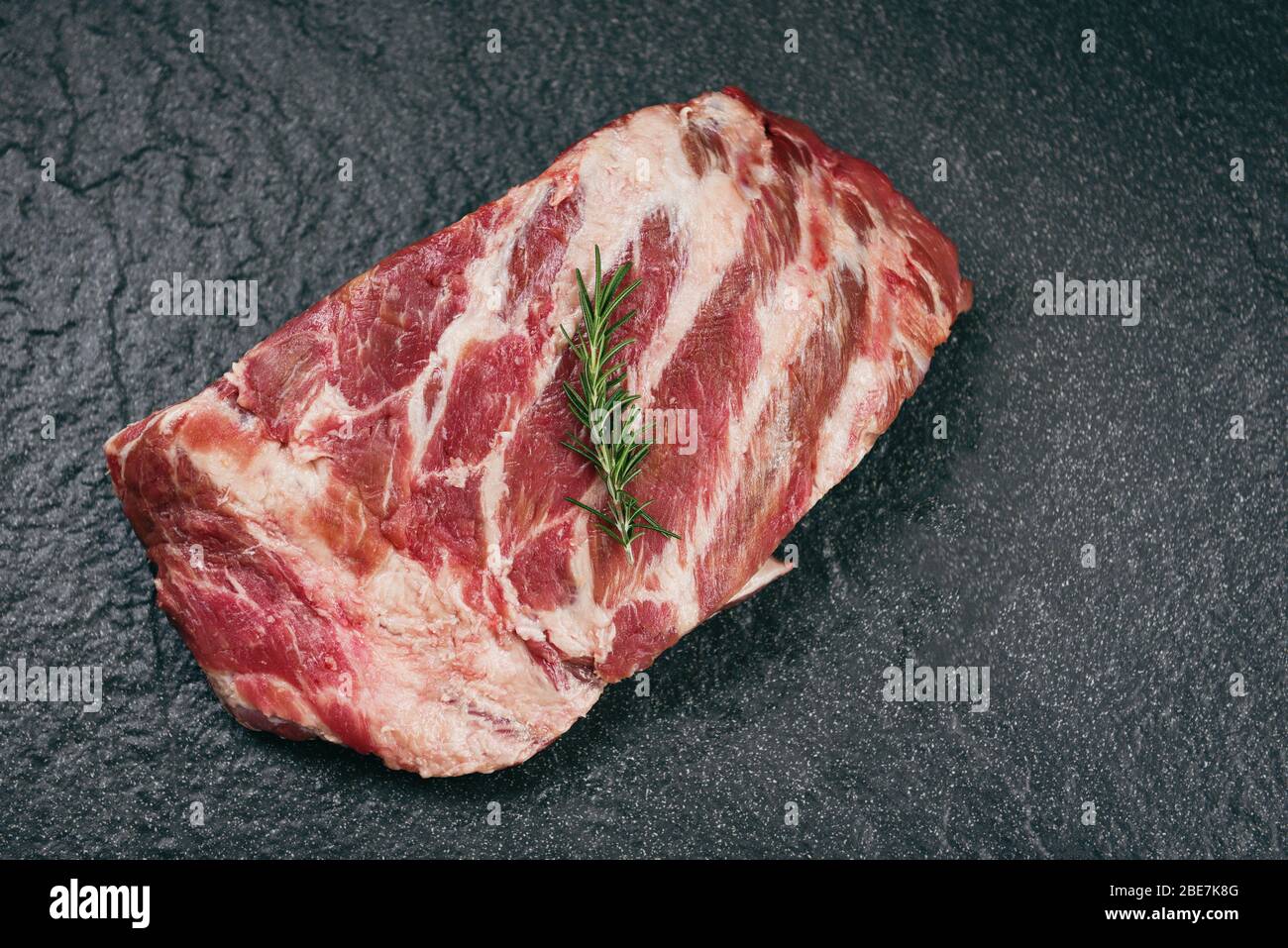Raw pork ribs meat on black plate background / Fresh pork spare ribs ...