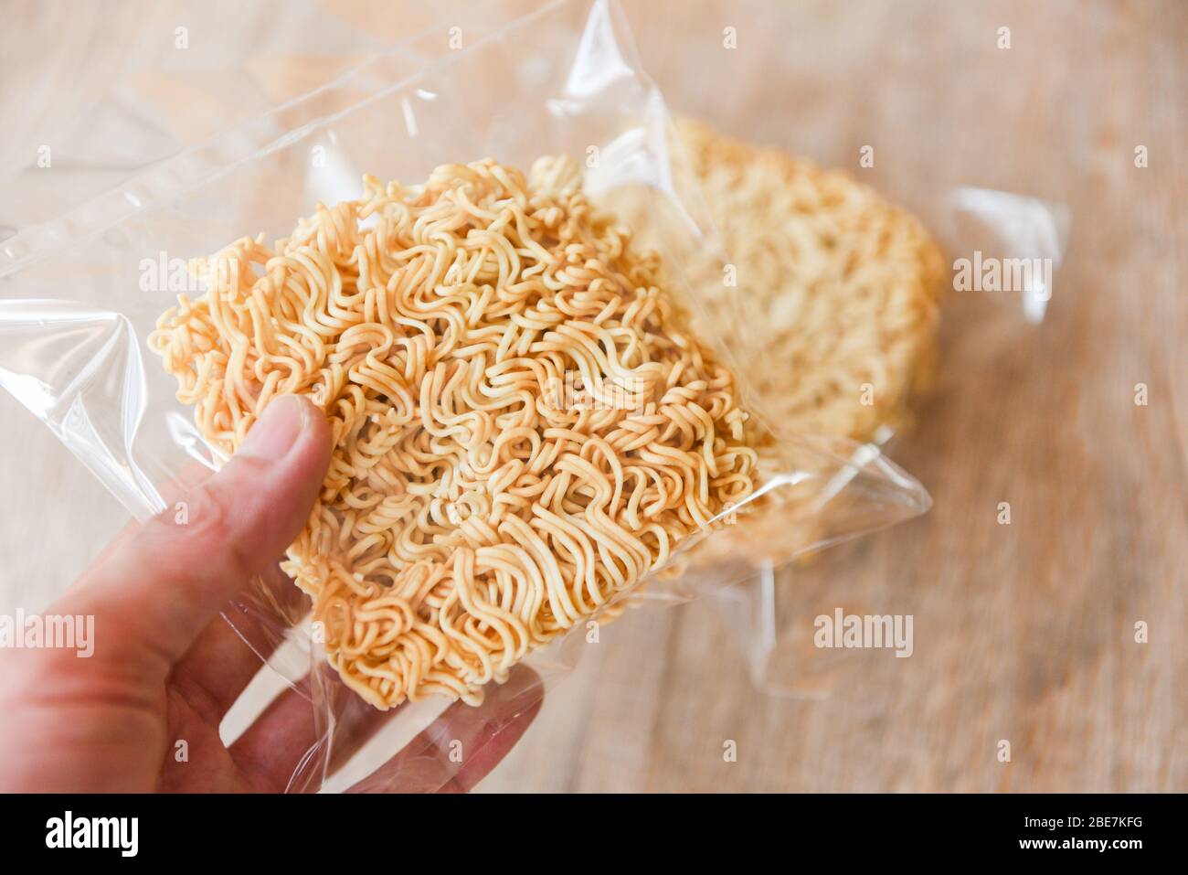 instant noodles in package in hand / dry food non perishable storage ...