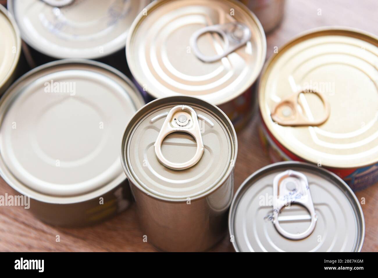 Various canned food in metal cans on wooden background , top view ...
