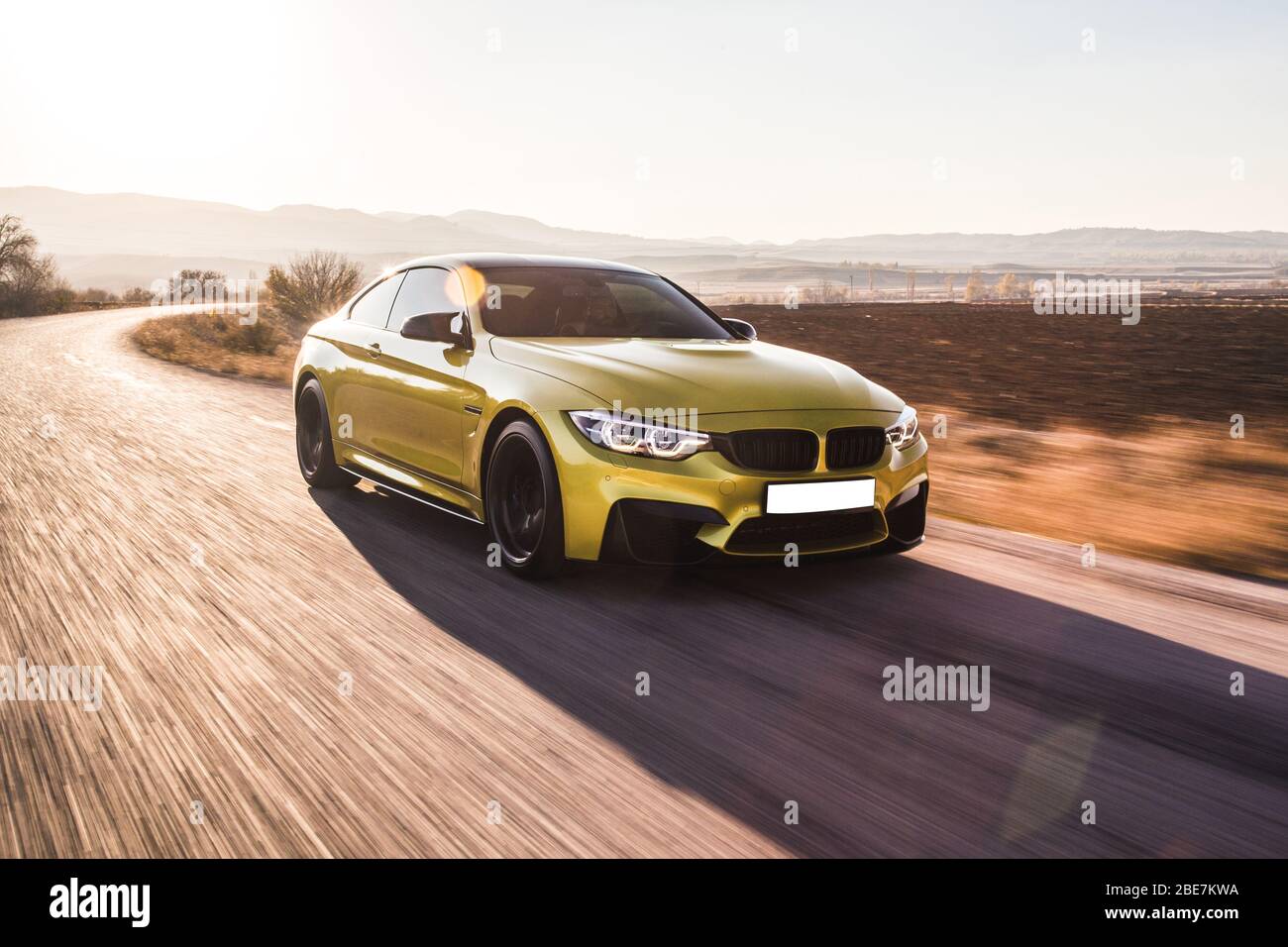 Green sedan car driving on the highway under the sunlight Stock Photo ...