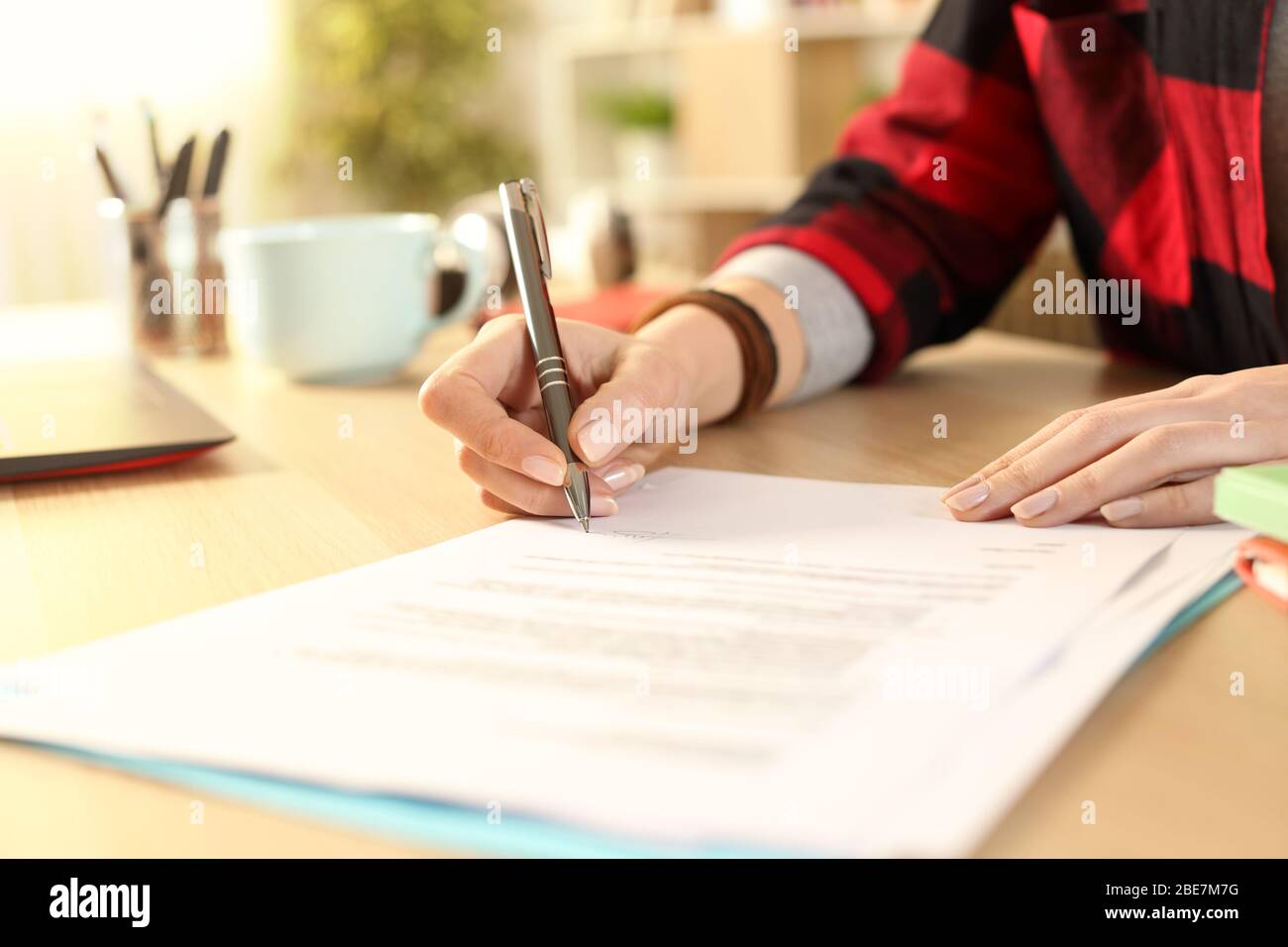 Close up of student girl hands signing contract on a desk at home Stock ...