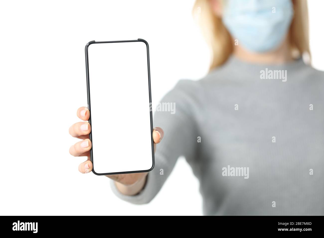 Close up of woman hand with protective mask showing blank phone screen ...
