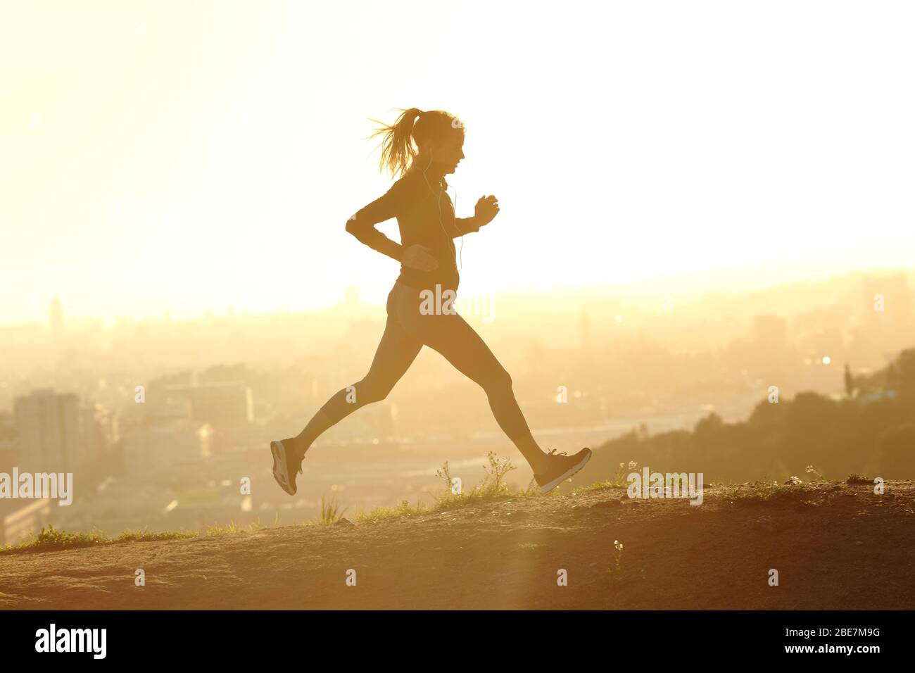 Female runner at sunset hi-res stock photography and images - Alamy