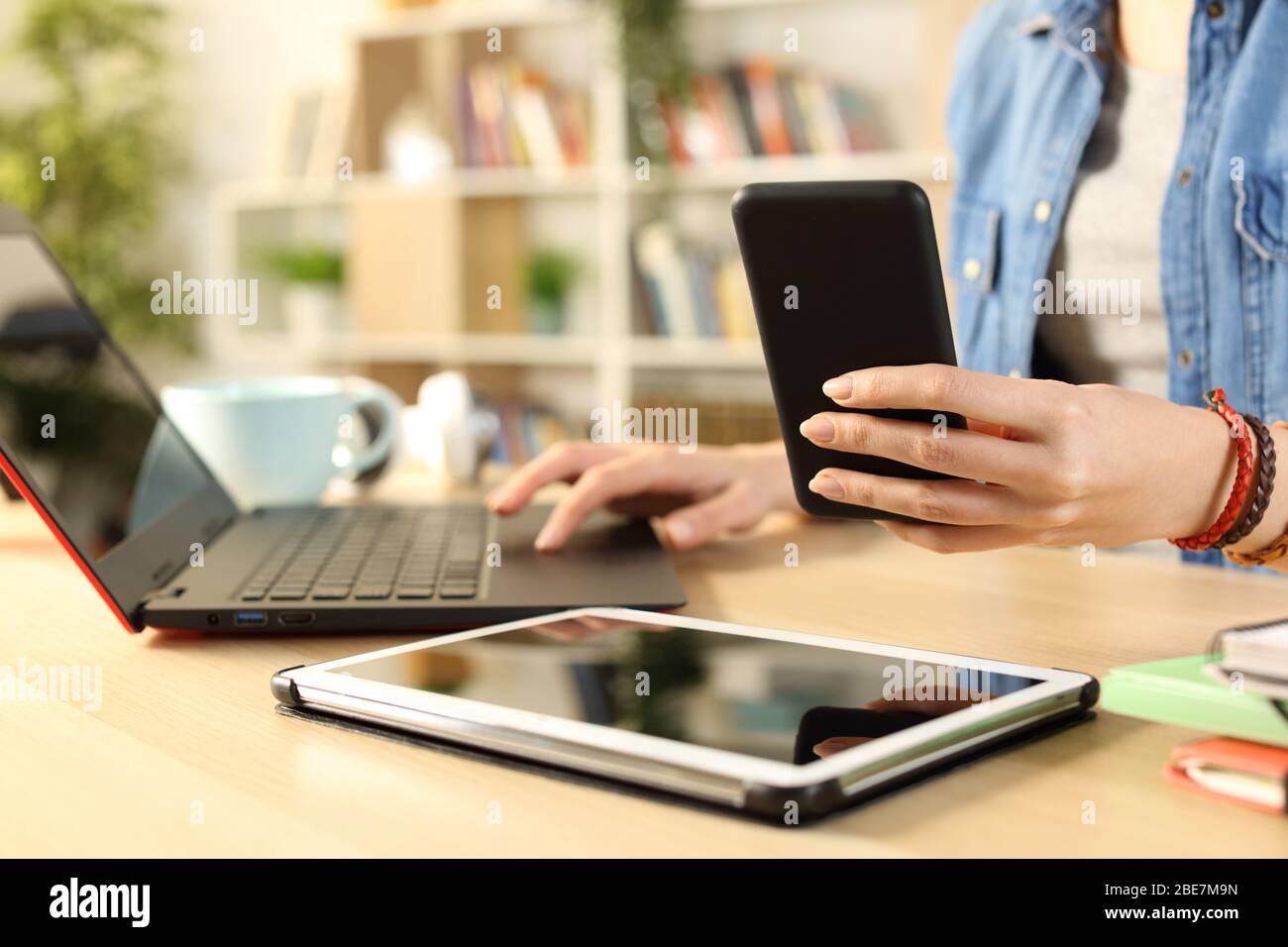 Close up of student girl hands using multiple devices sitting on a desk at home Stock Photo - Alamy