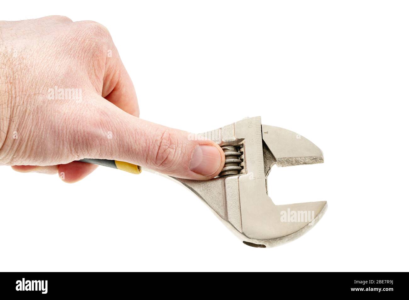 male hand adjusts the size of an adjustable wrench isolated on white ...