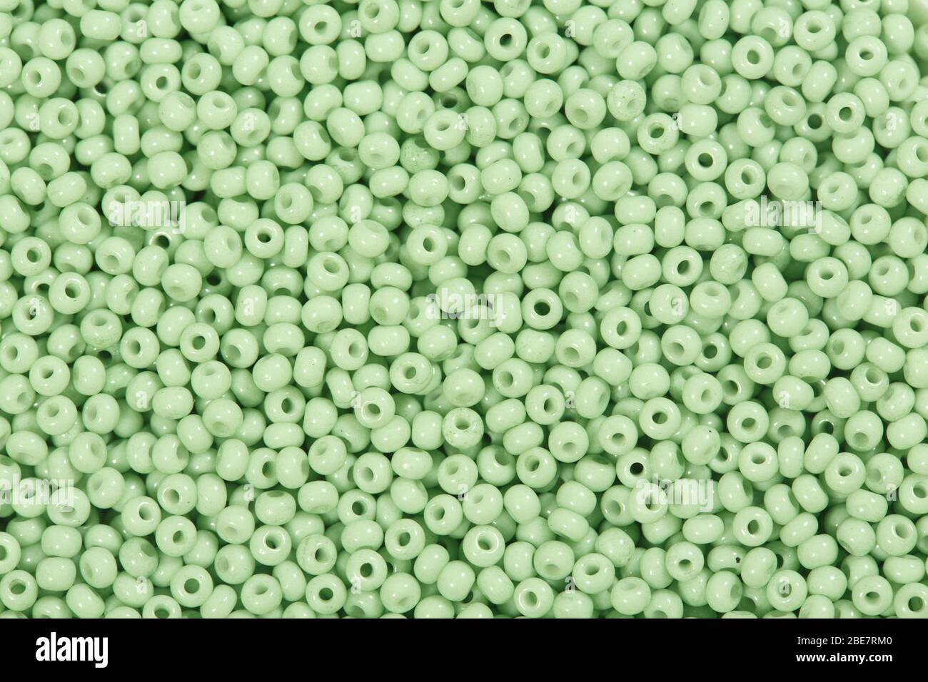 Pale green seed beads in texture form Stock Photo - Alamy