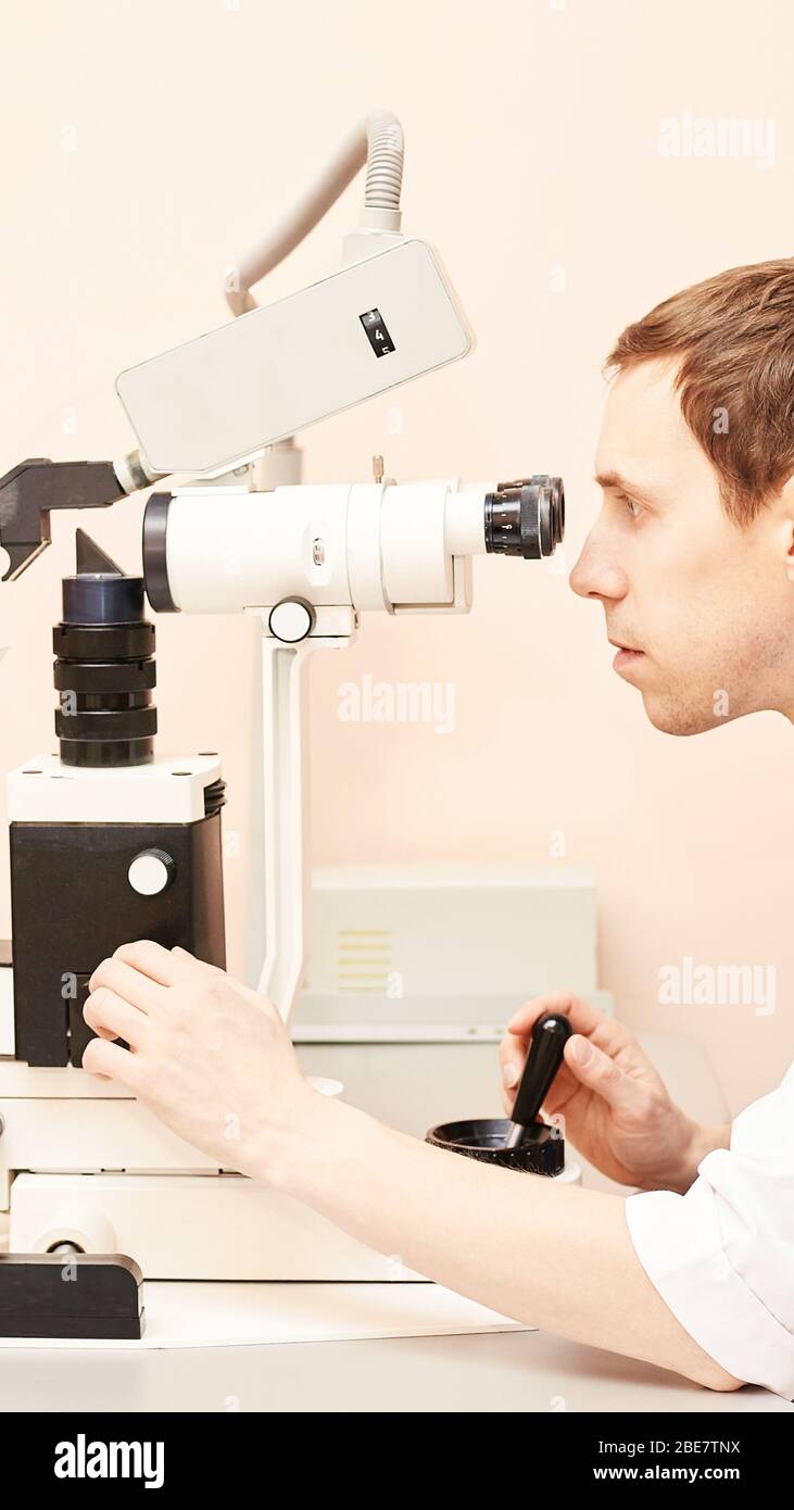 ophthalmologist doctor in exam optician laboratory with male patient ...