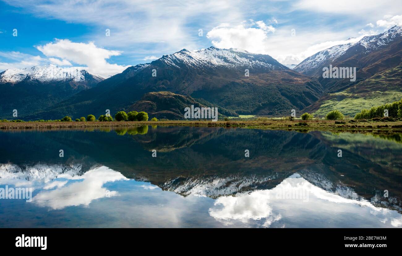 Mountain range reflected in a lake, Matukituki Valley, Mount Aspiring ...