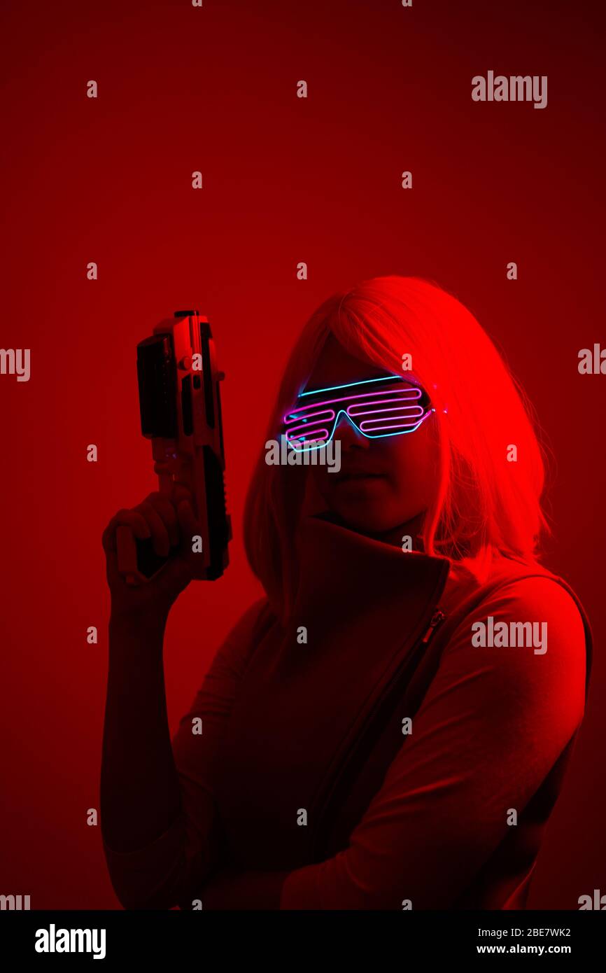 Girl with blaster in the futuristic battle. Concept virtual reality ...