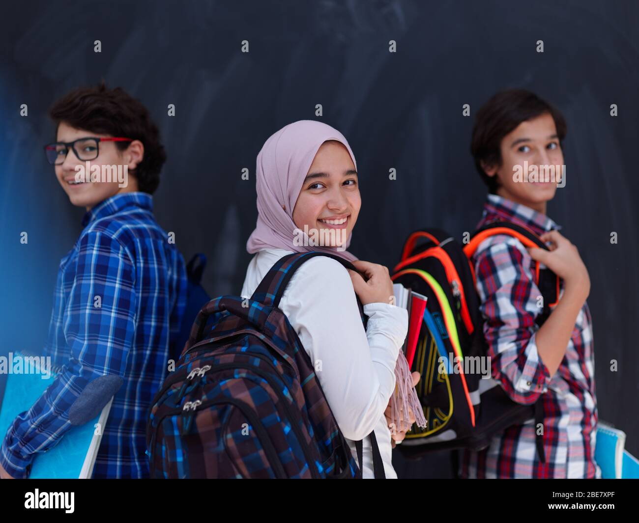 Arabic teenagers, students group portrait against black chalkboard ...