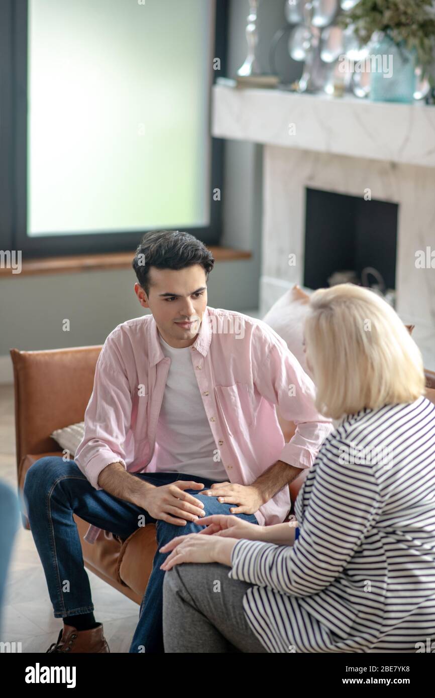 Hope. Young man in a pink shirt feeling hopeful Stock Photo - Alamy