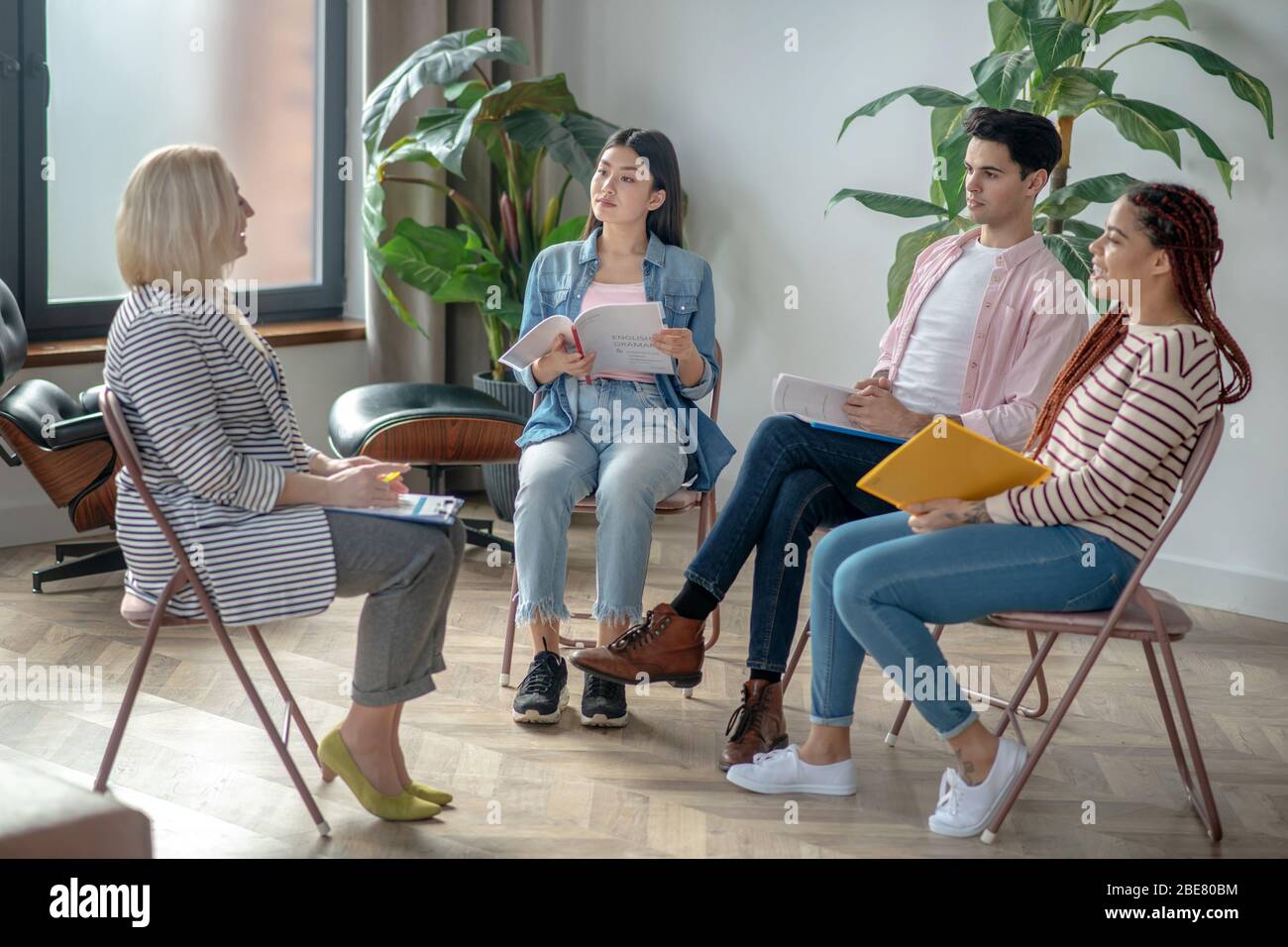 Interesting conversation. Three young people sitting and listening to ...