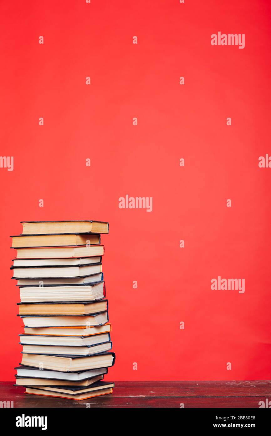 many stacks of educational books to study in the college library on a ...