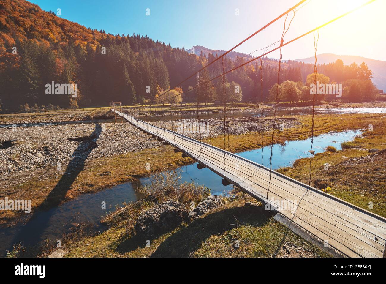 Wooden hanging rope bridge over mountain river Stock Photo - Alamy
