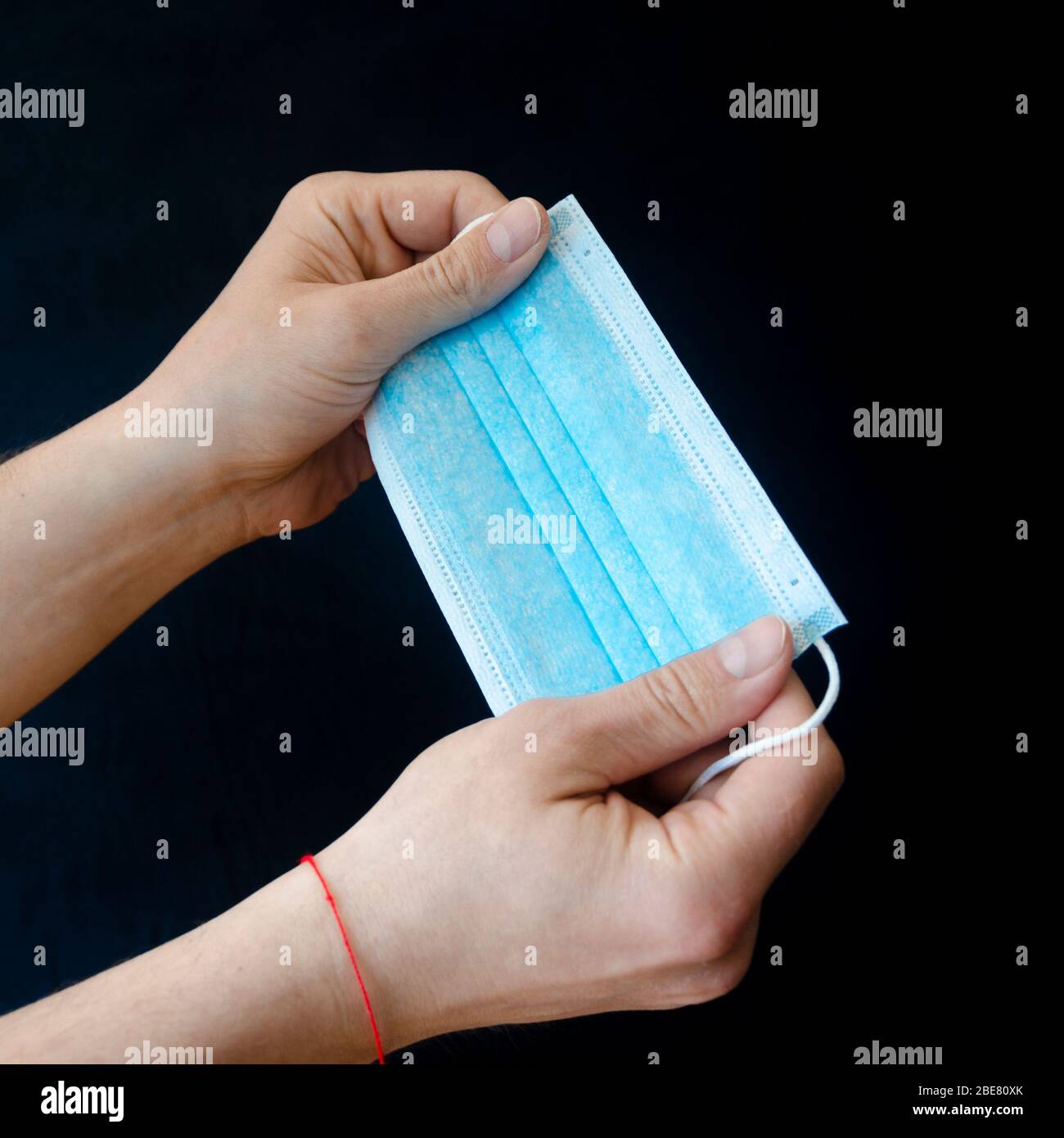 Medical protective blue masks in the hands of a man Stock Photo - Alamy