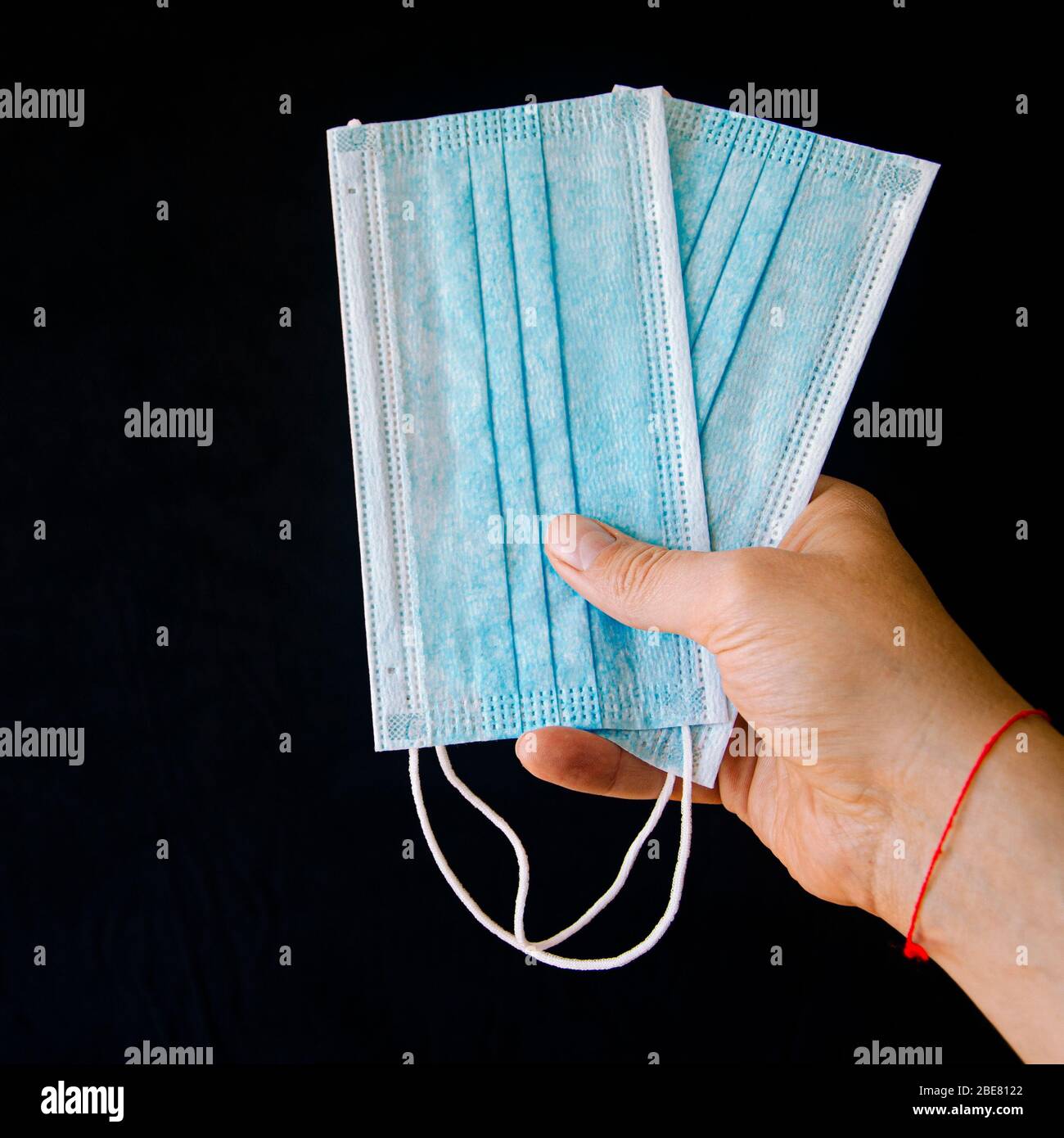 Medical protective blue masks in the hands of a man Stock Photo - Alamy