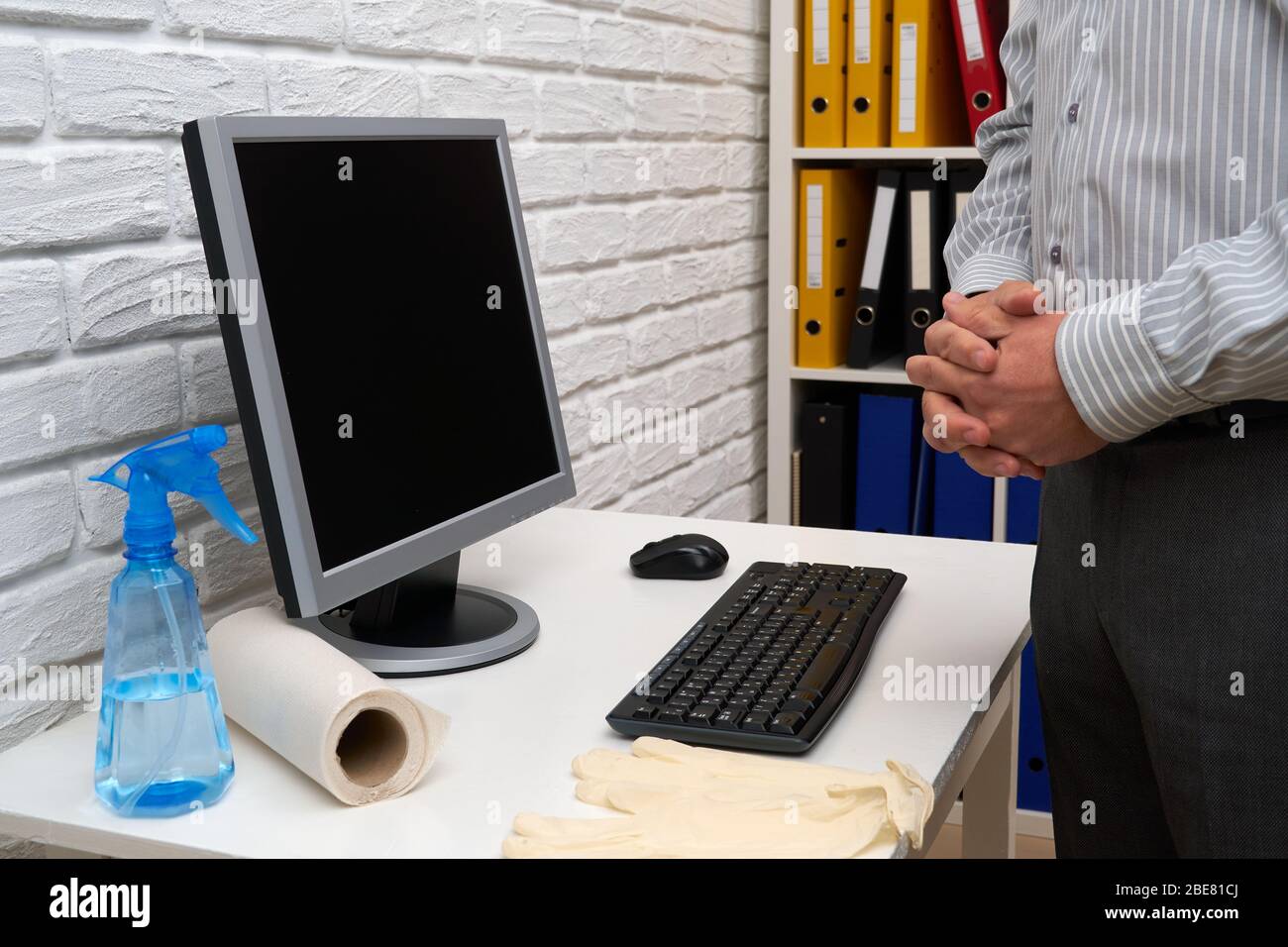 concept of cleaning or disinfecting the office - a businessman cleans ...