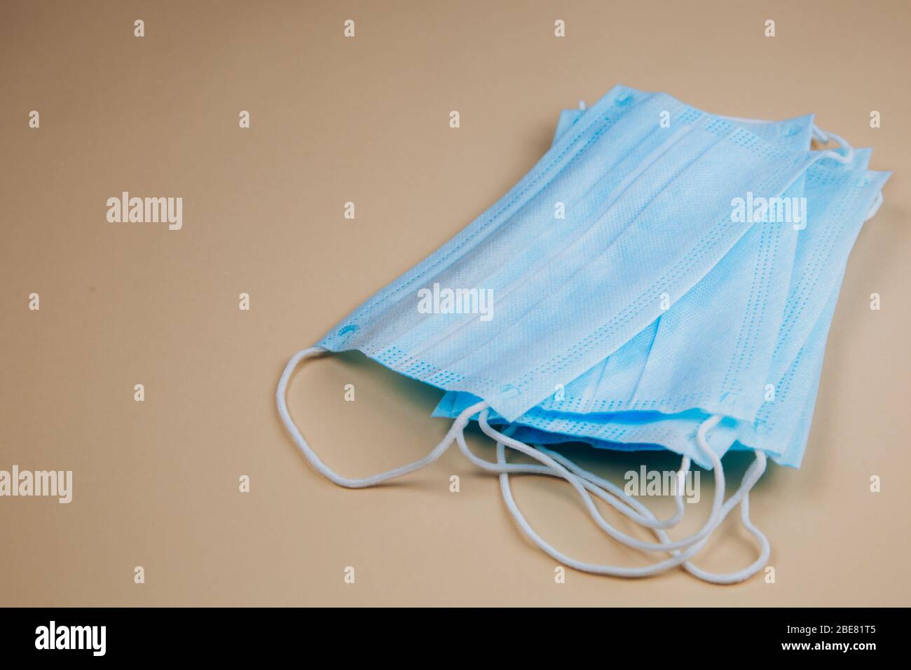 Medical protective mask on a beige background. A disposable surgical ...