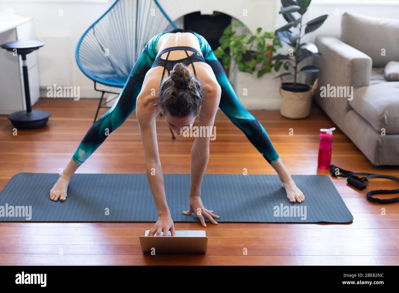 Caucasian woman stretching at home during coronavirus Covid19 pandemic ...