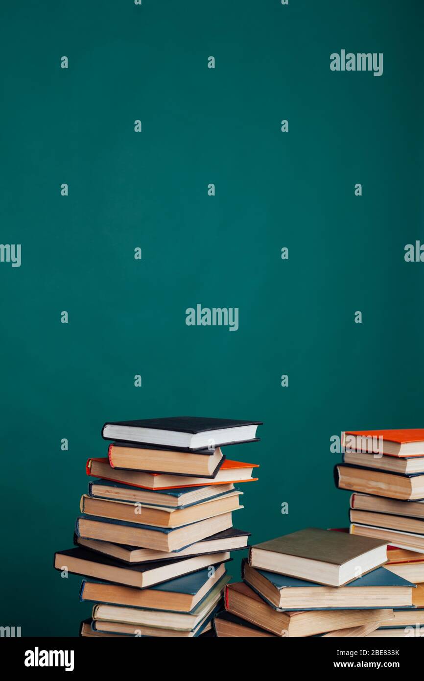 many stacks of educational books to teach in the school library on a ...