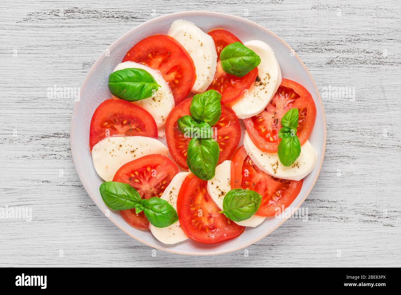 Delicious Caprese Salad With Ripe Tomatoes And Mozzarella Cheese With