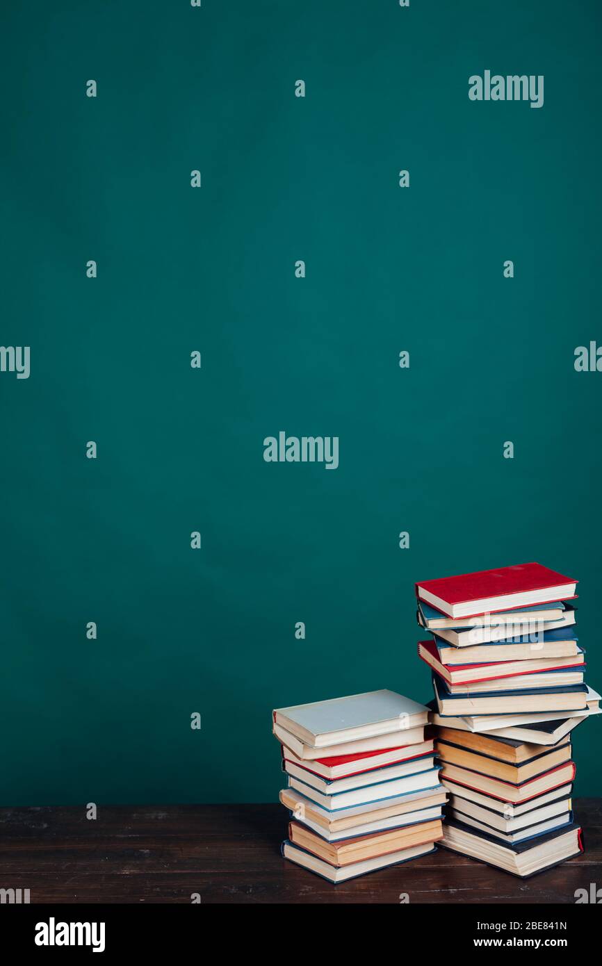 many stacks of educational books to teach in the school library on a ...