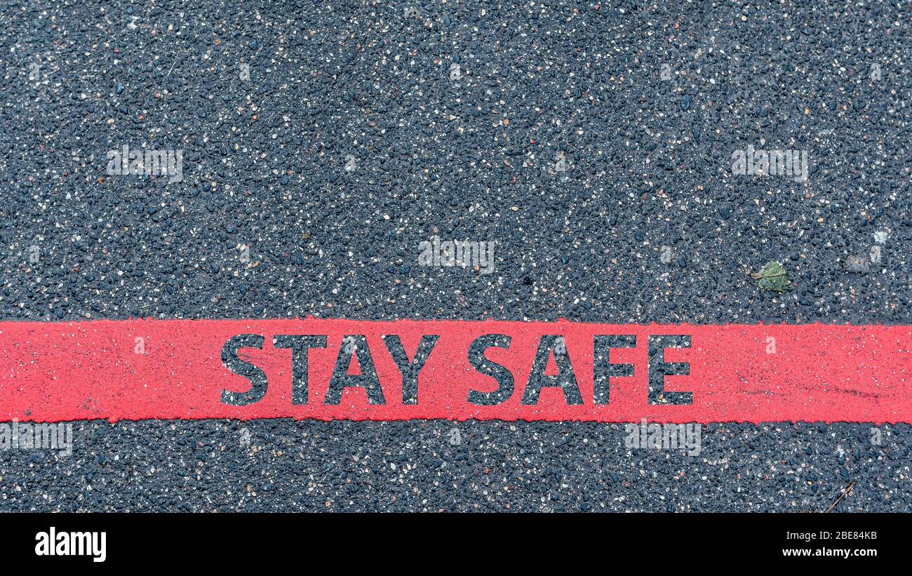 top View of the asphalt road with red line and text STAY SAFE ...
