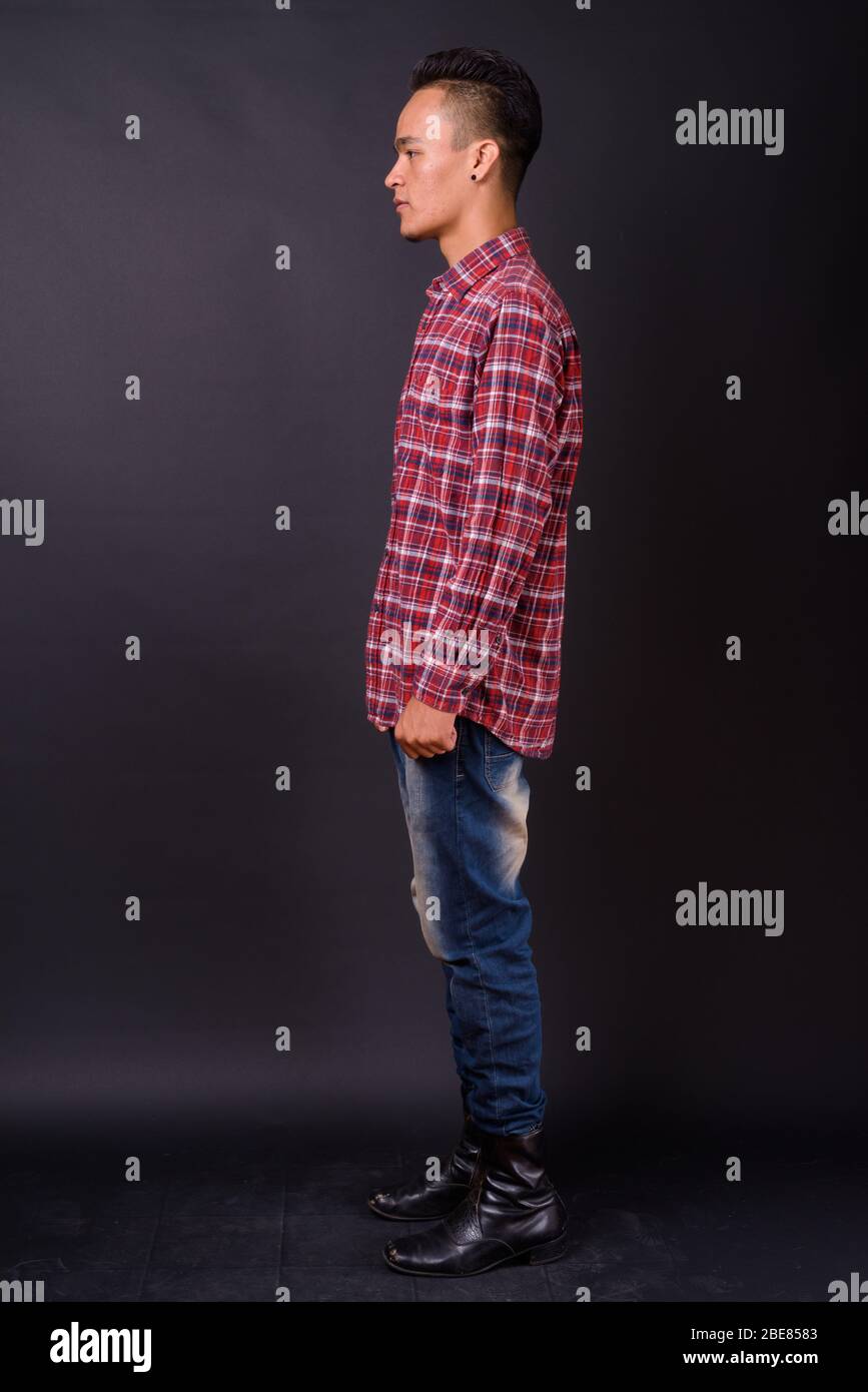 Full body shot profile view of young handsome Indian hipster man Stock ...
