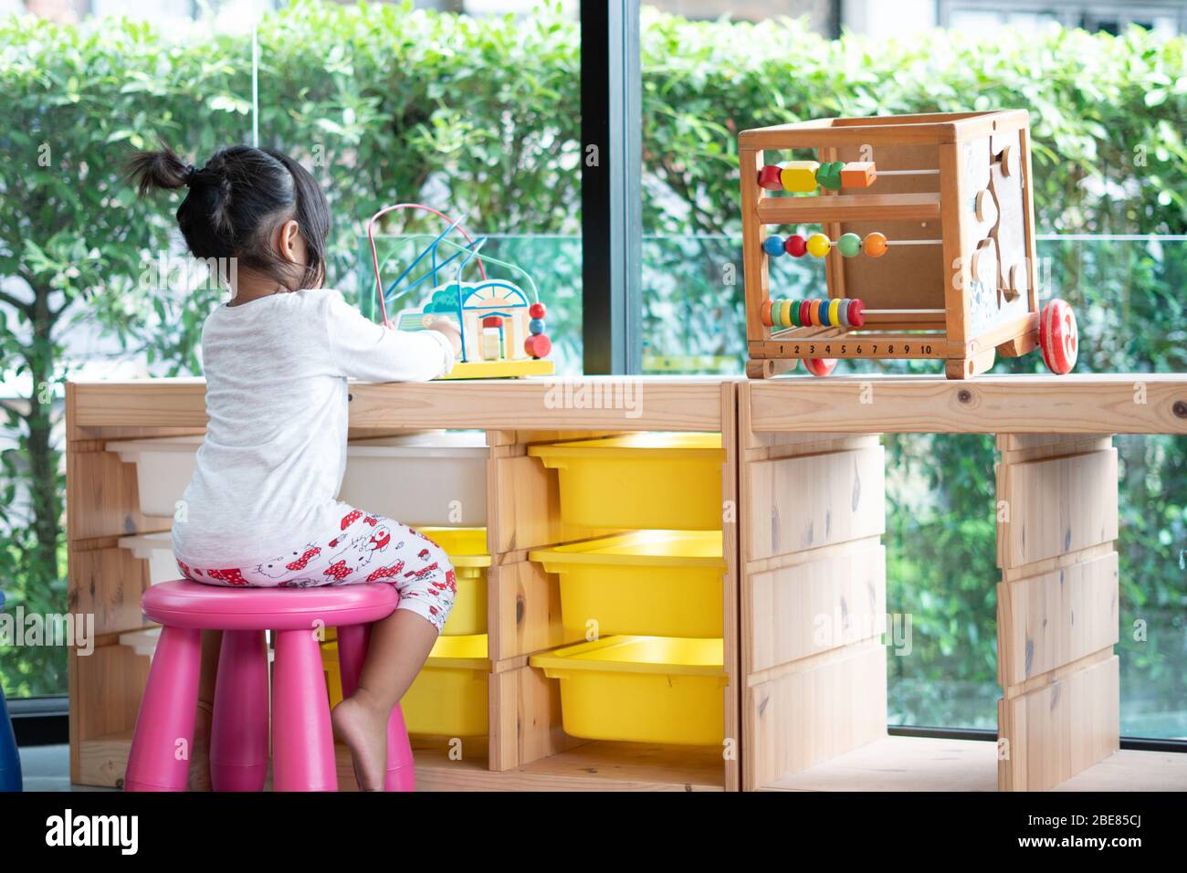 Kids learnfrom play with colourful wooden toy on table top at home ...