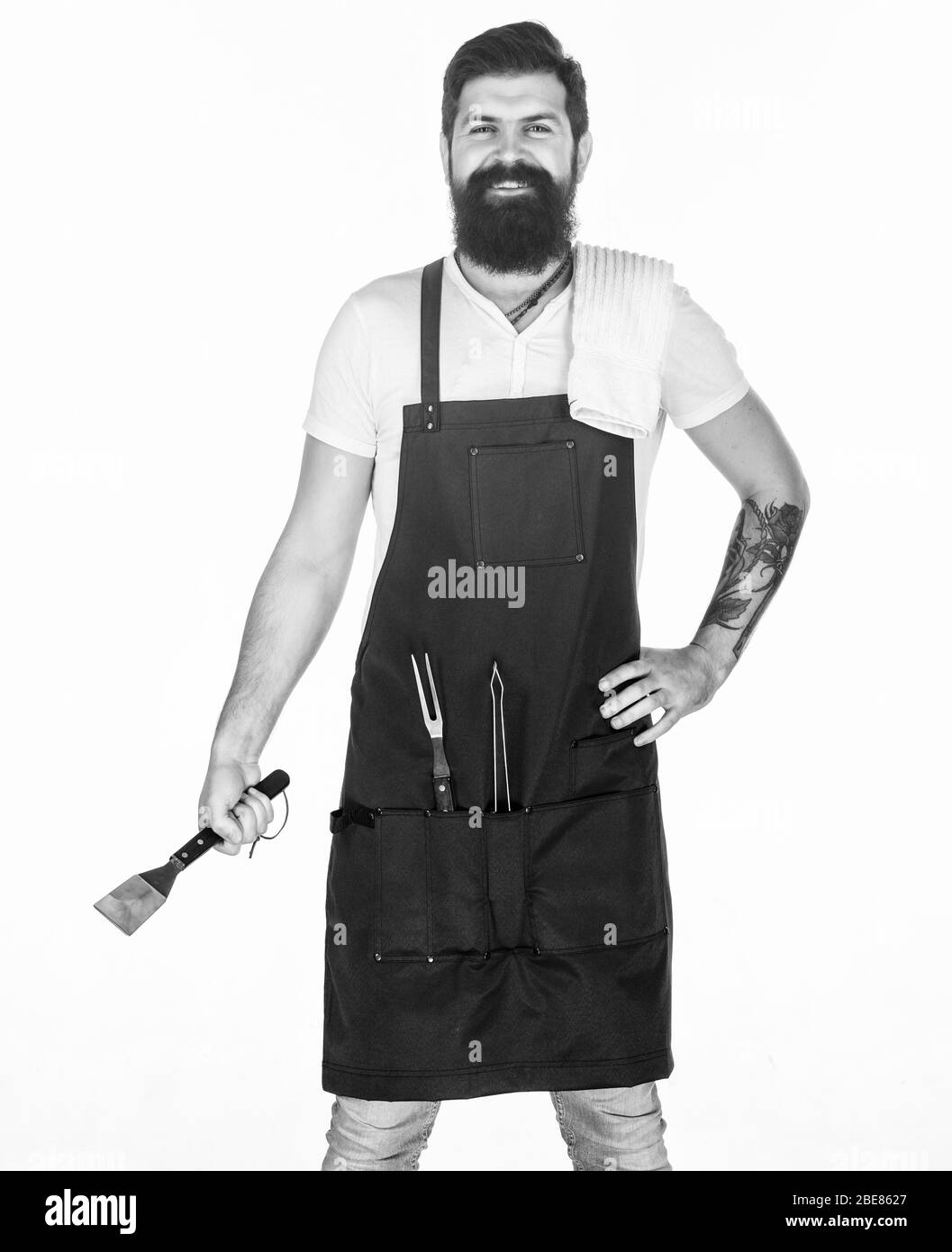 Professional barbecue utensil. Bearded hipster wear apron for barbecue ...