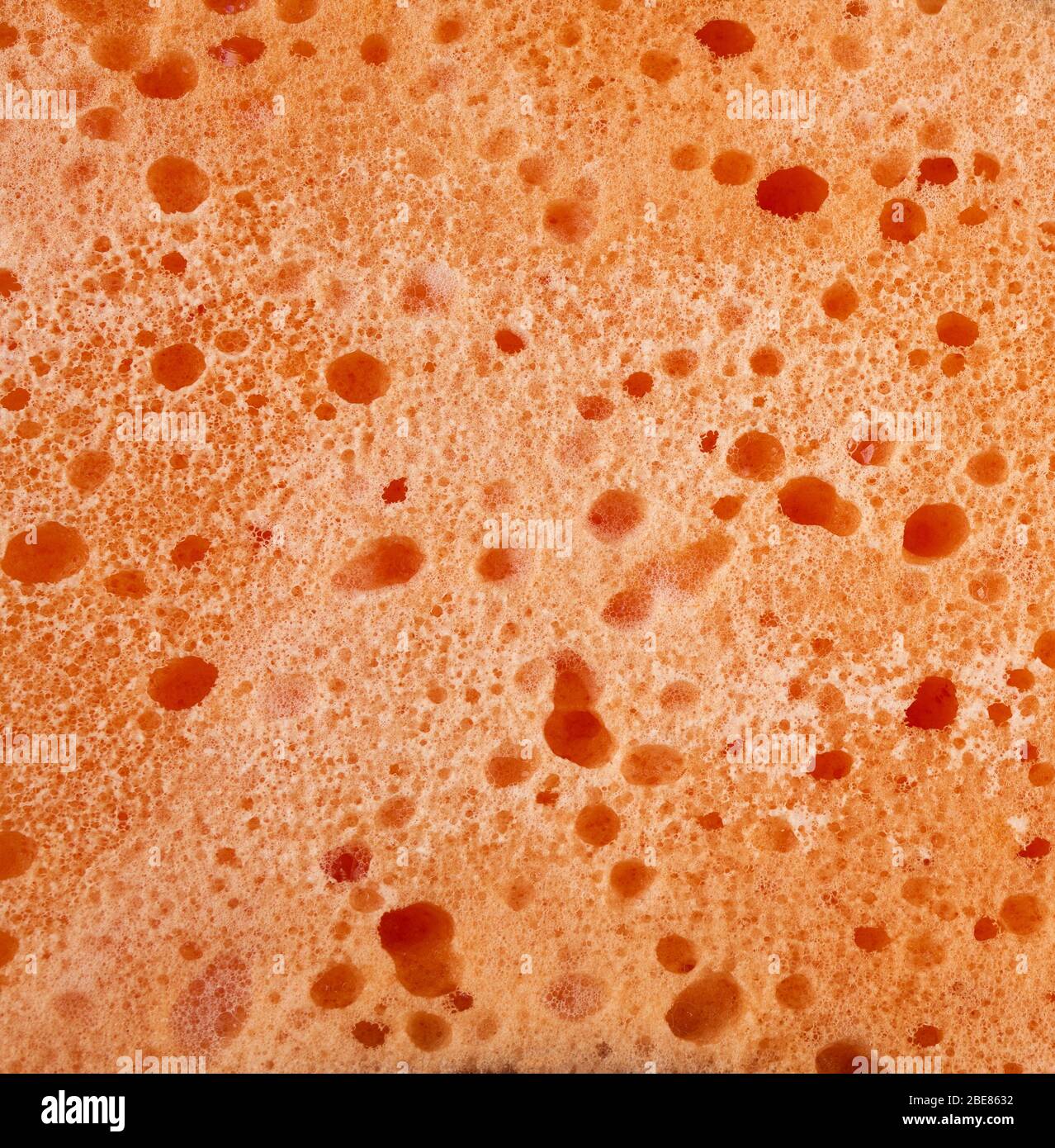 texture of wet orange washcloths with white foam, full frame, close up ...