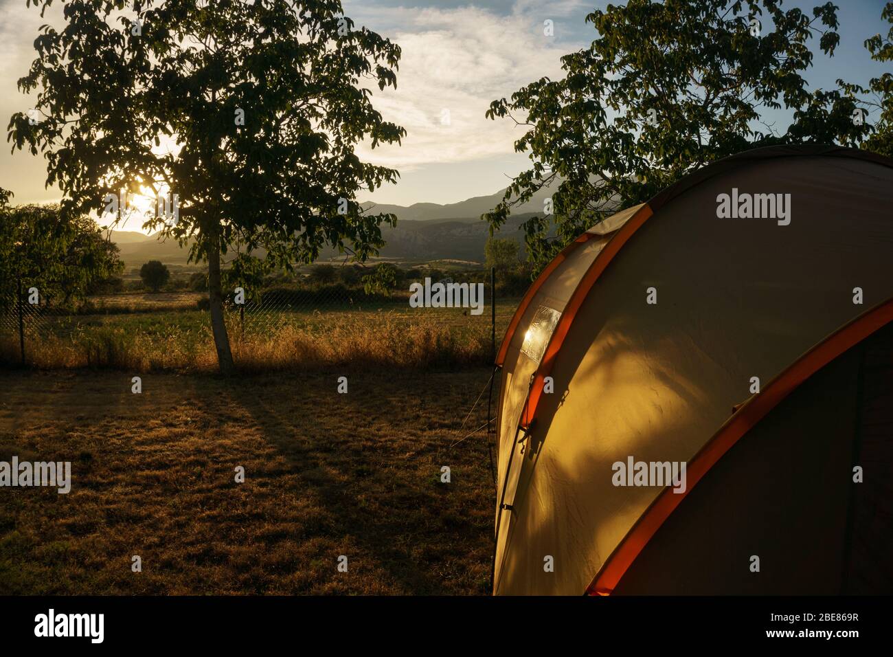 Landscape of a tent in a camping. Sunset lighting Stock Photo - Alamy