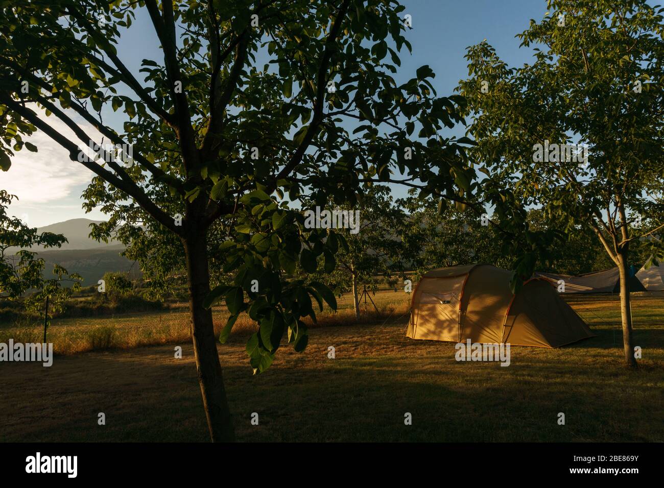 Landscape of a tent in a camping. Sunset lightingLandscape of a tent in ...