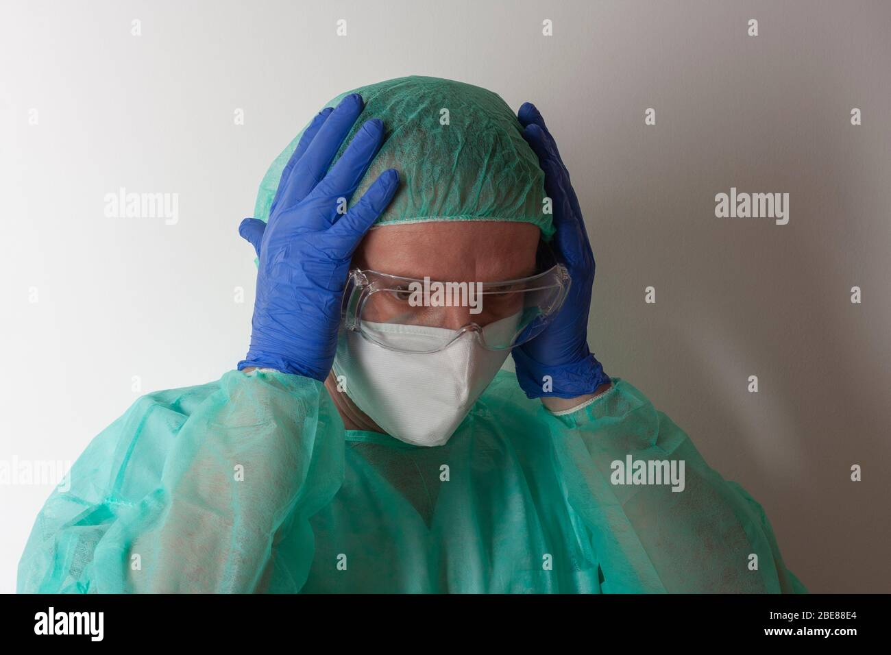 Male nurse, with plastic protective eyeglasses and respirator ffp2, cap ...